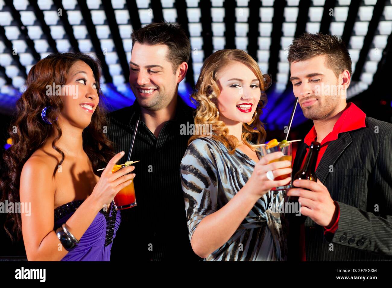 Group of party people with cocktails in a bar or club having fun Stock ...