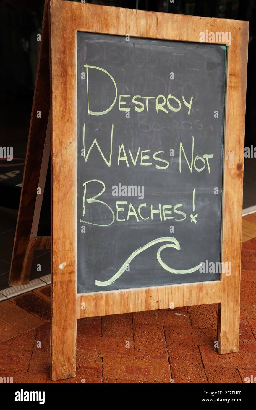 Blackboard with Destroy Waves Not Beaches signage Stock Photo - Alamy