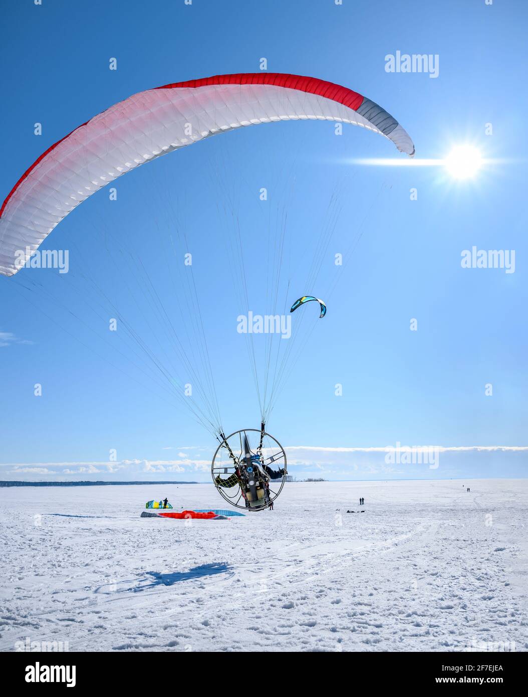 The first moments of taking off a motor paraplane over a large snow ...