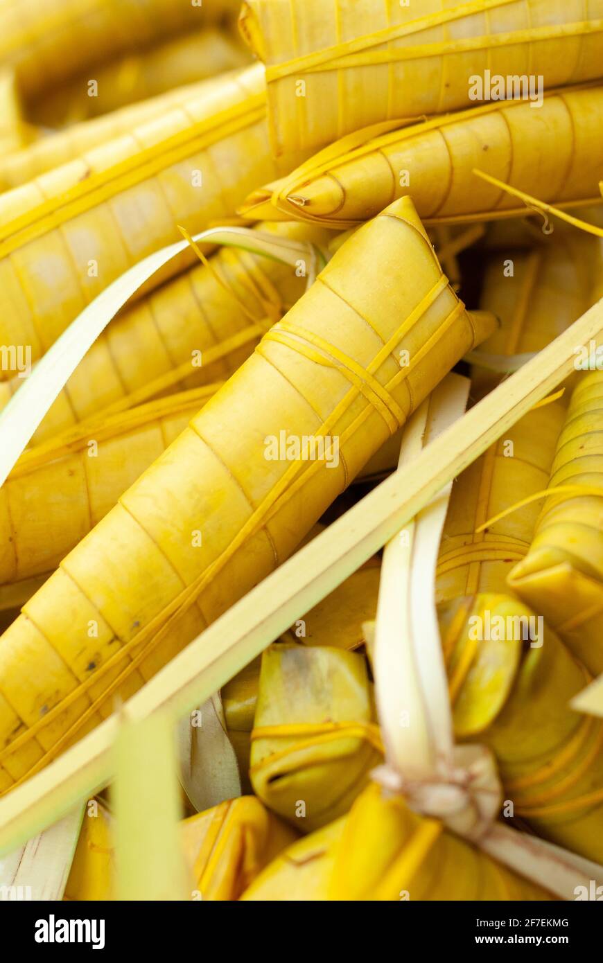 Filipino delicacy wrapped in coconut leaves and hanging for display ...