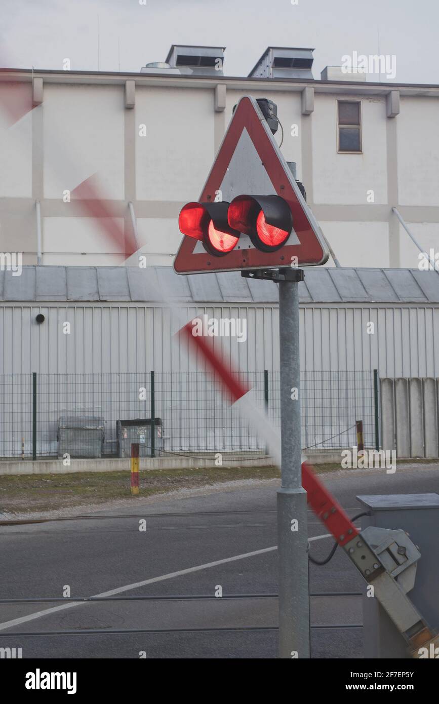 Barrier going down on a train crossing. Lights are flashing and barrier ...