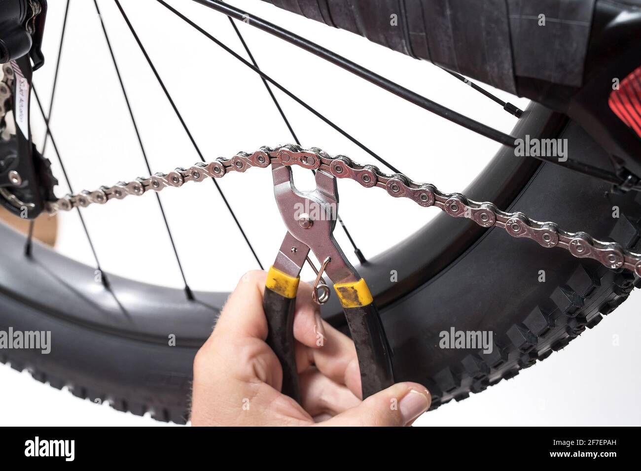 Bicicle repair or maintenance. Breaking the chain of a bicycle apart ...
