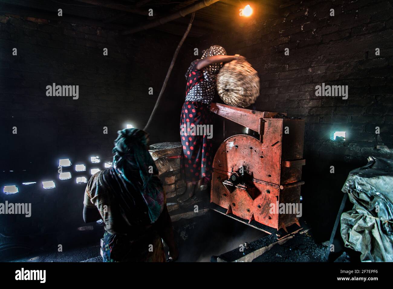 A female labour works on coal at a brickfield at Khulna, Bangladesh ...