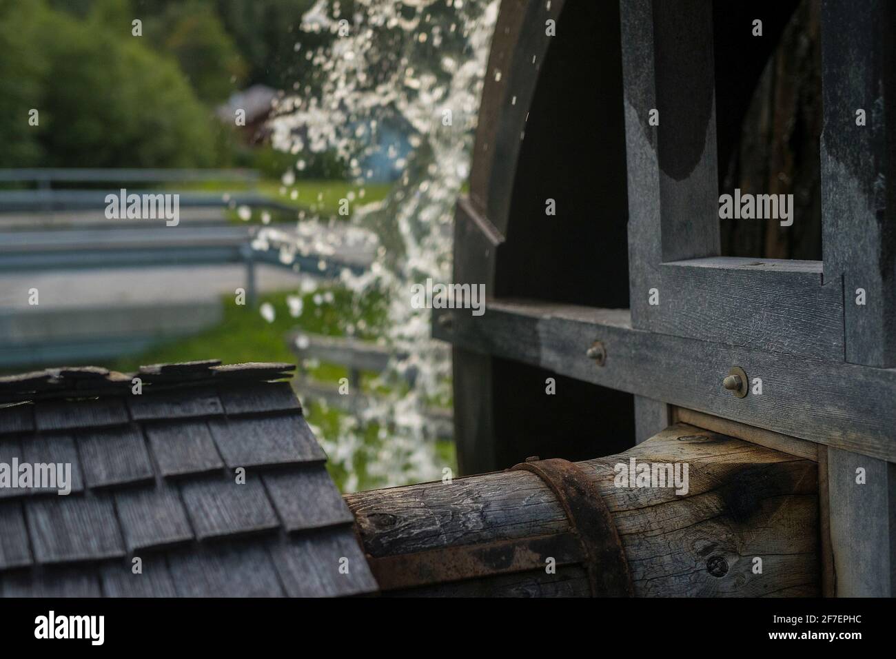 Wooden wheel of an old vintage mill. Water splashing from the wheel ...