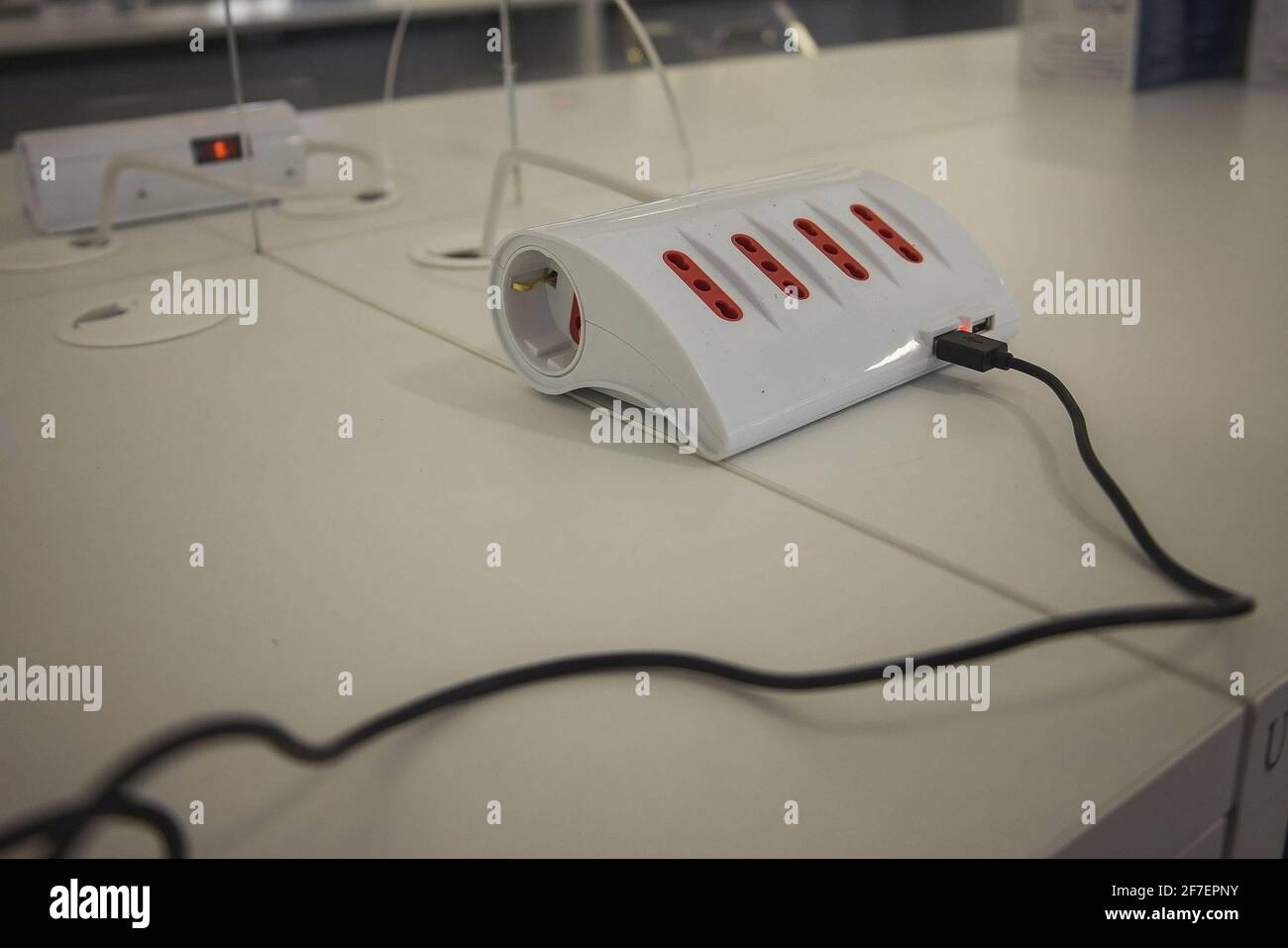 Electrical distribution box or adapter on a desk in an office center ...
