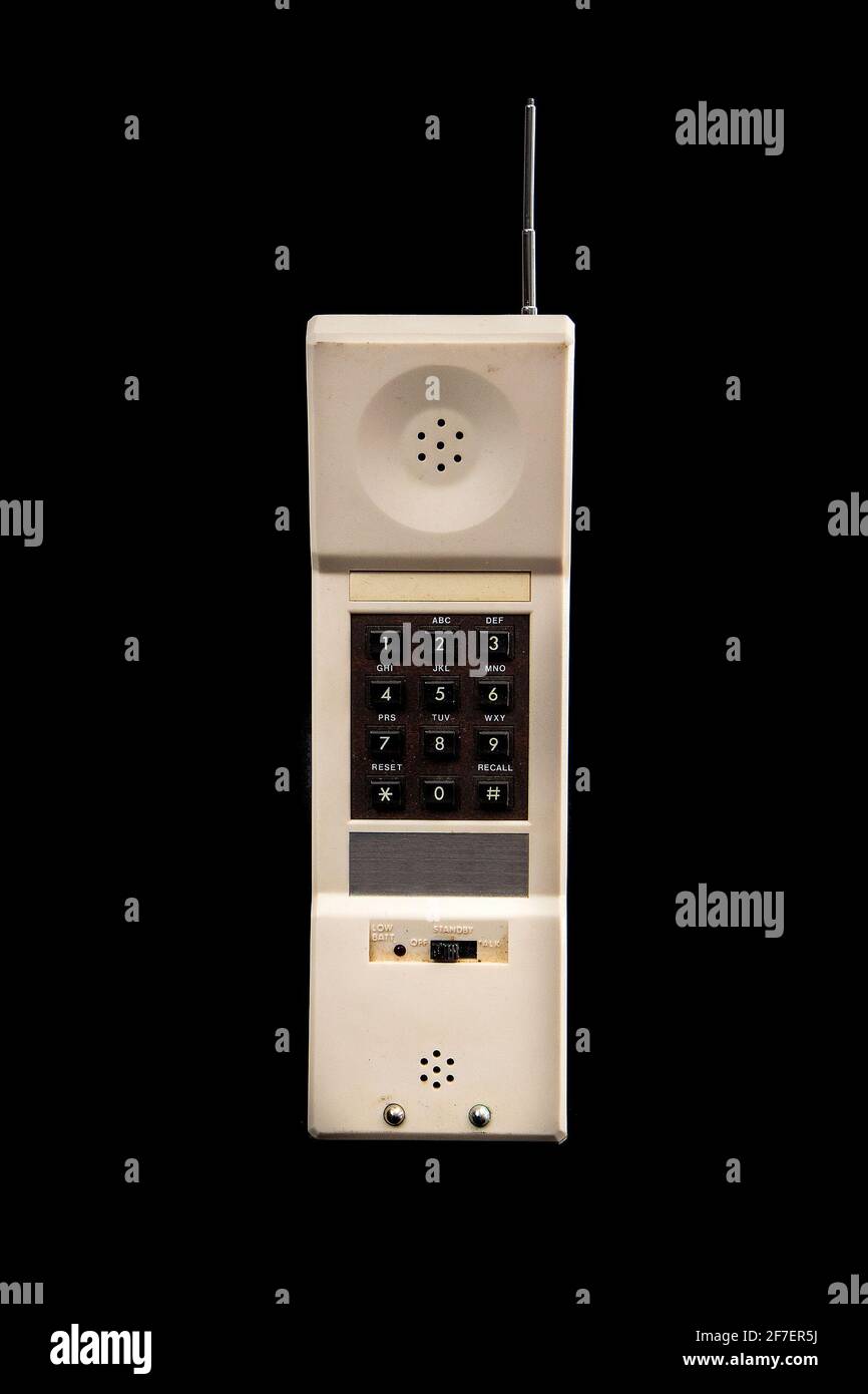 An old white vintage cordless telephone from the eighties isolated on ...