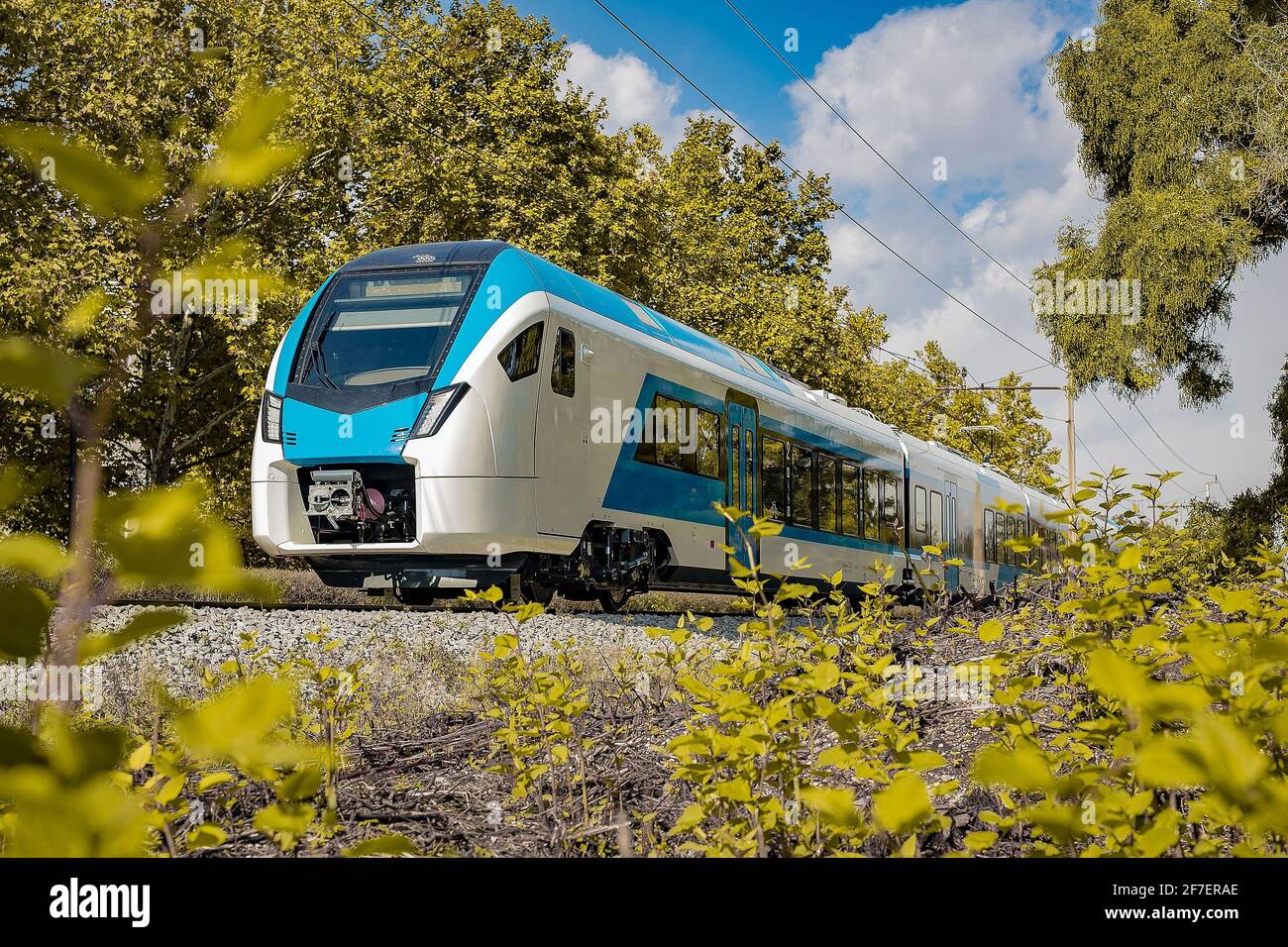Modern and new passenger commuter Train in white and blue color is ...