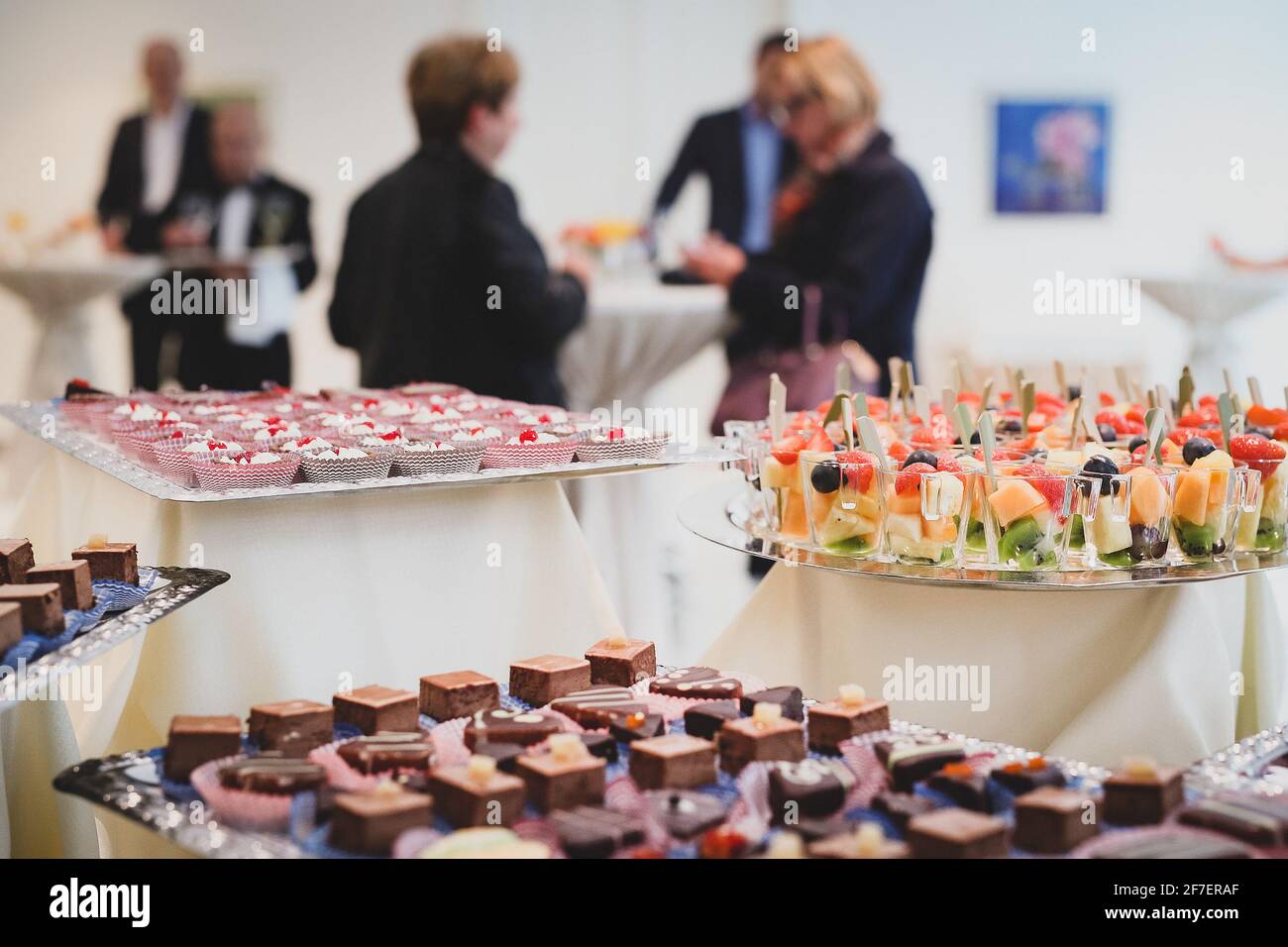 A collection of different sweets like chocolate, cupcakes and fruit on ...