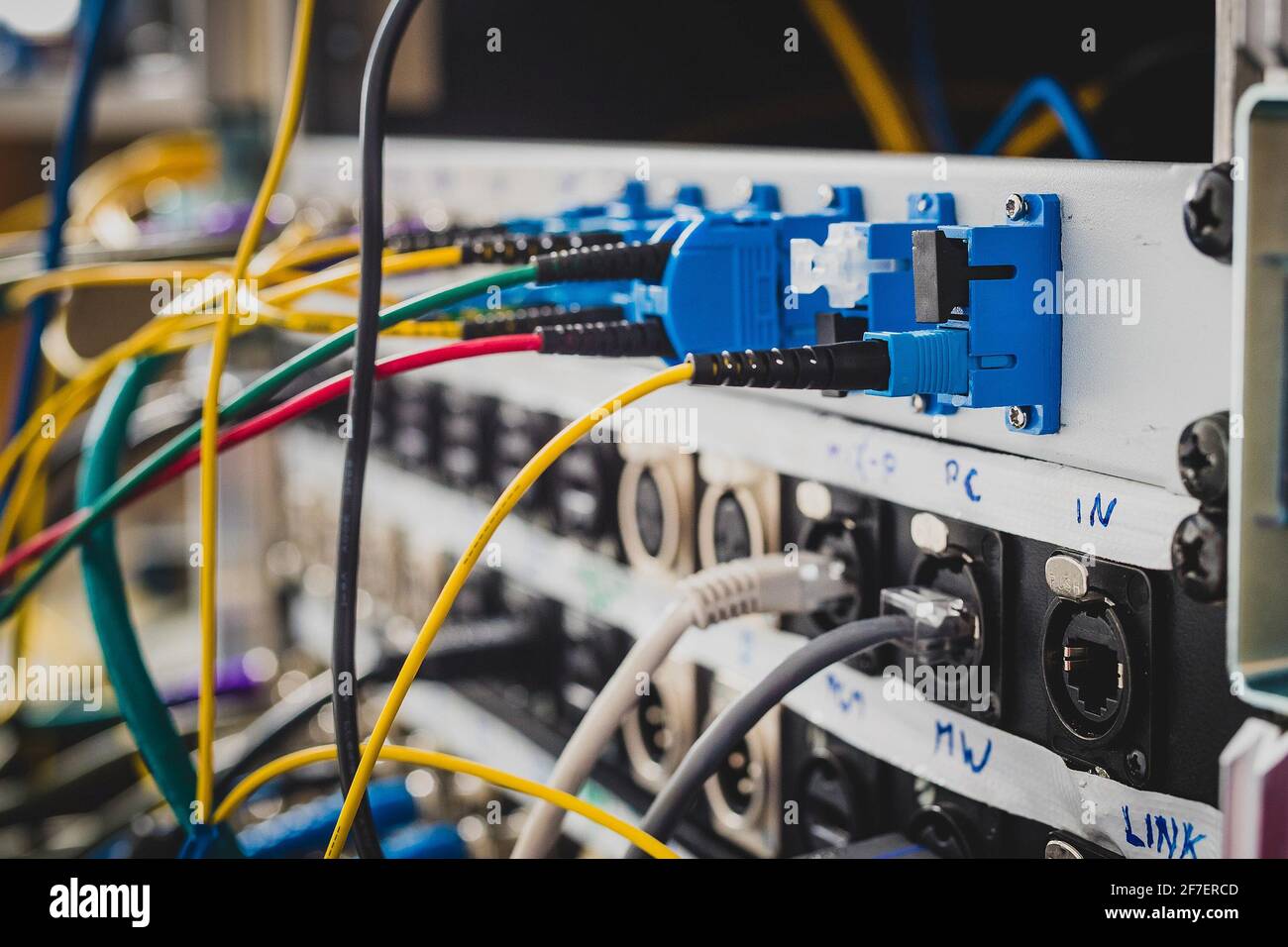 Different BNC SDI UTP and optical signal cables plugged in the back of ...