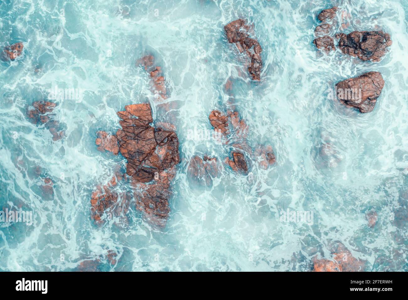 Ocean swirls and motion around rocky boulders Stock Photo - Alamy