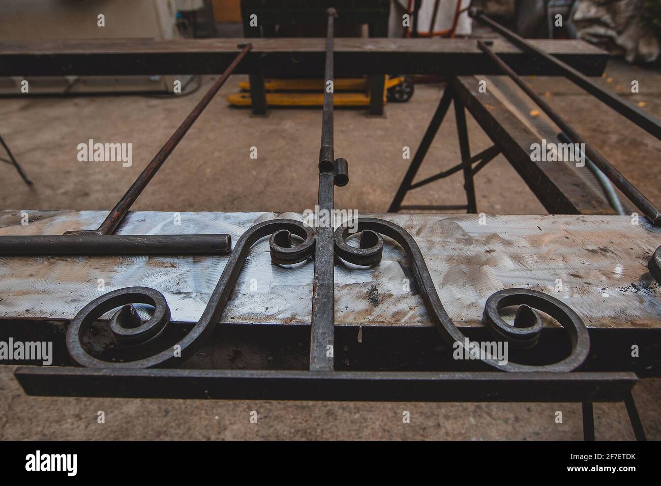 Blacksmith shop with a part of a railing being made and welded together ...
