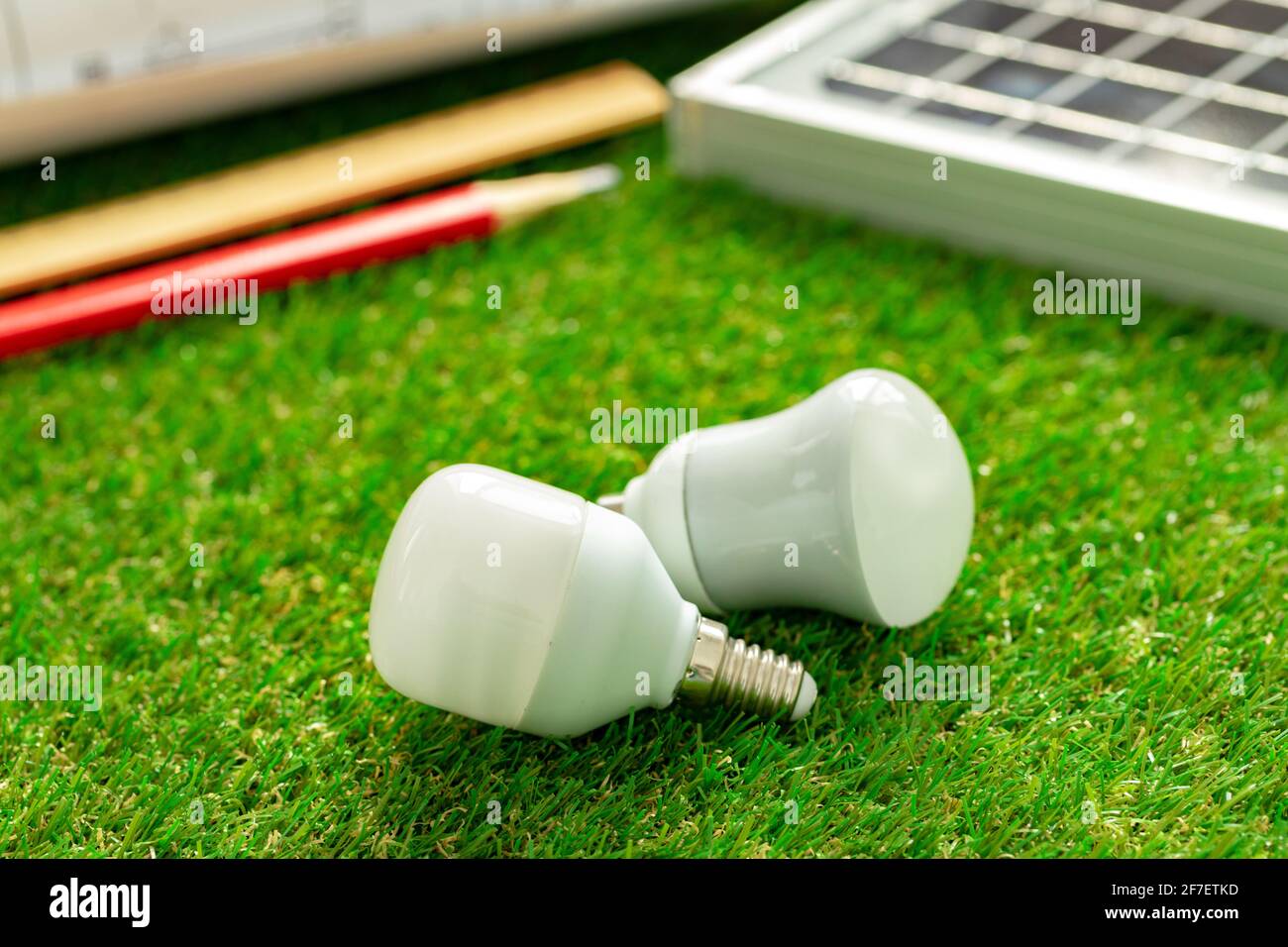 Solar energy panel and light bulb, green energy Stock Photo - Alamy