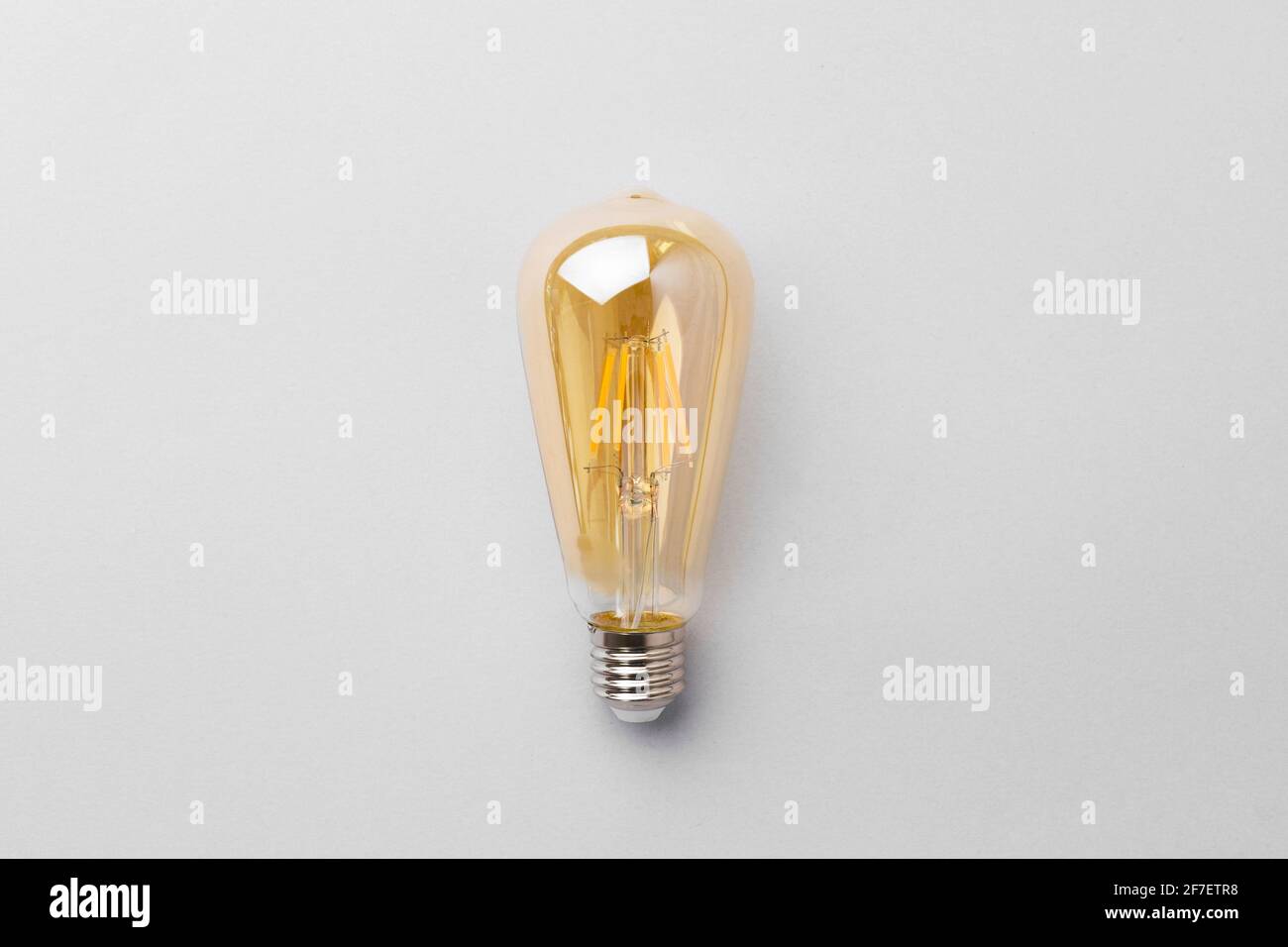 Light bulb on light grey paper background Stock Photo - Alamy