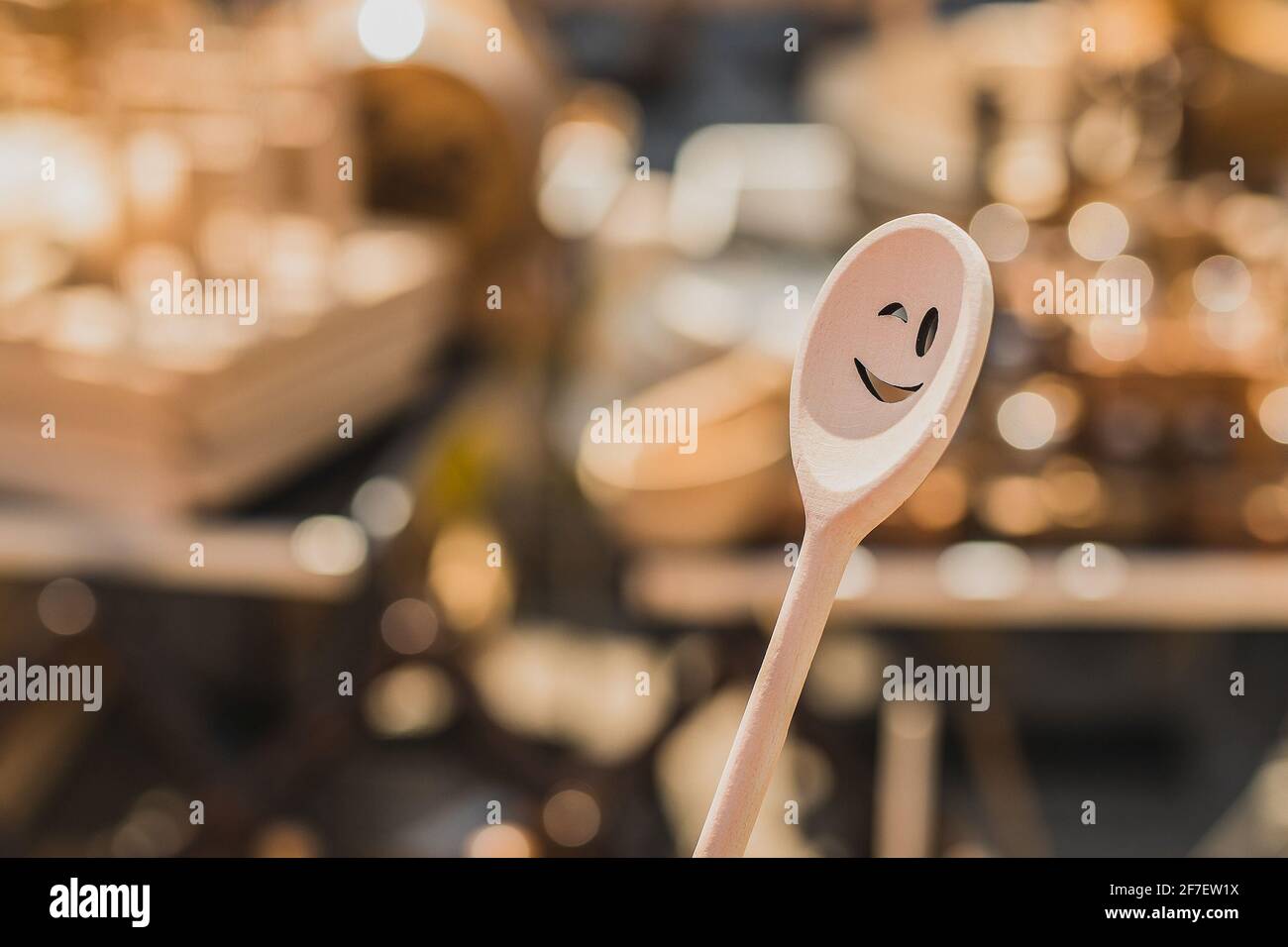 Wooden smiley face spoon outdoors. Image of a kitchen utensil making a ...
