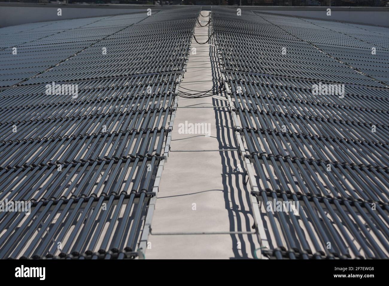 Round tubular solar panels installed on a roof of a building Stock ...