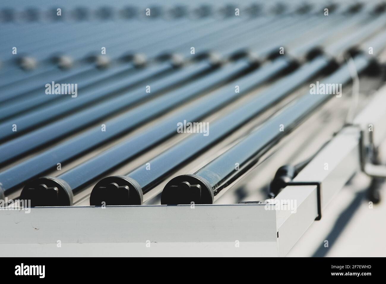 Detail of a round tubular solar panels installed on a roof of a ...