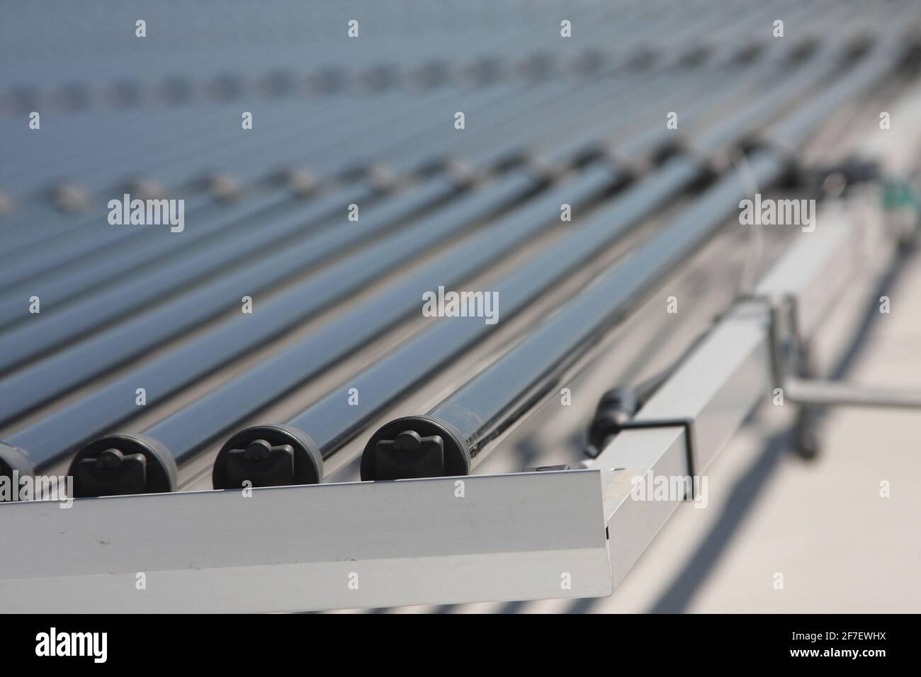 Detail of a round tubular solar panels installed on a roof of a ...