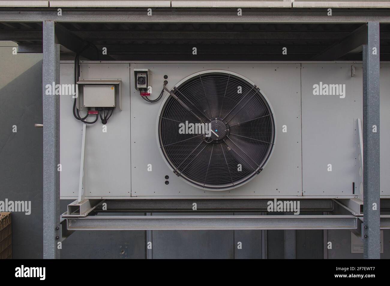 Outside part of industrial air conditioner unit mounted on a building ...