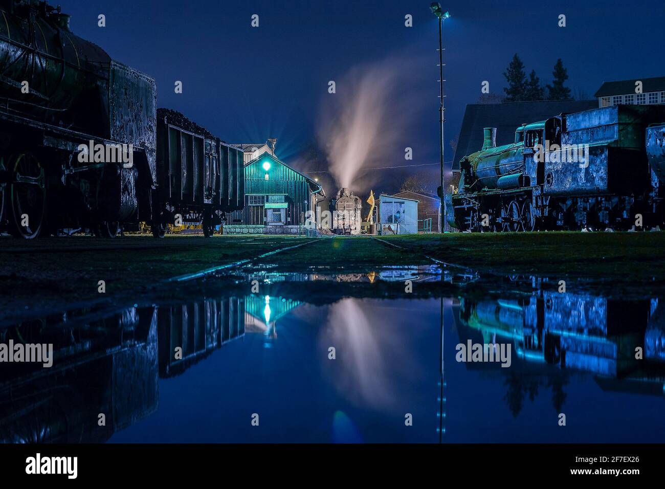 Old steam locomotive being fired up in front of a turntable during the ...