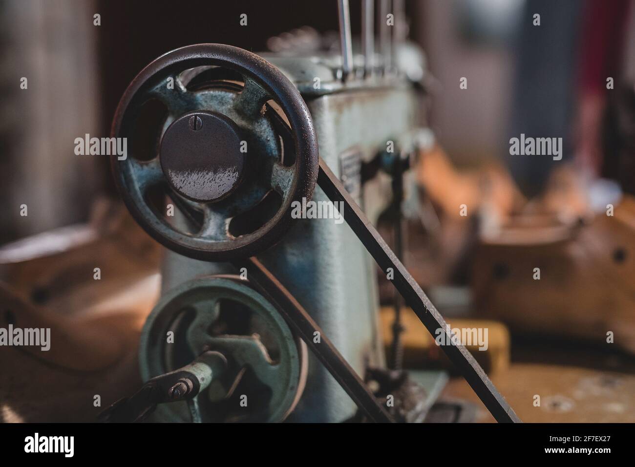 Old vintage sewing machine seen from the rear side exposing the drive ...