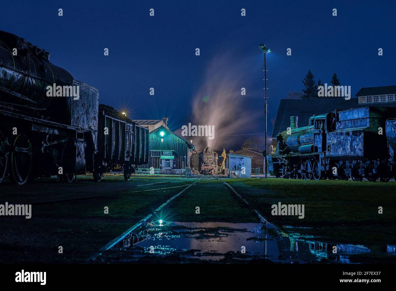 Old steam locomotive being fired up in front of a turntable during the ...