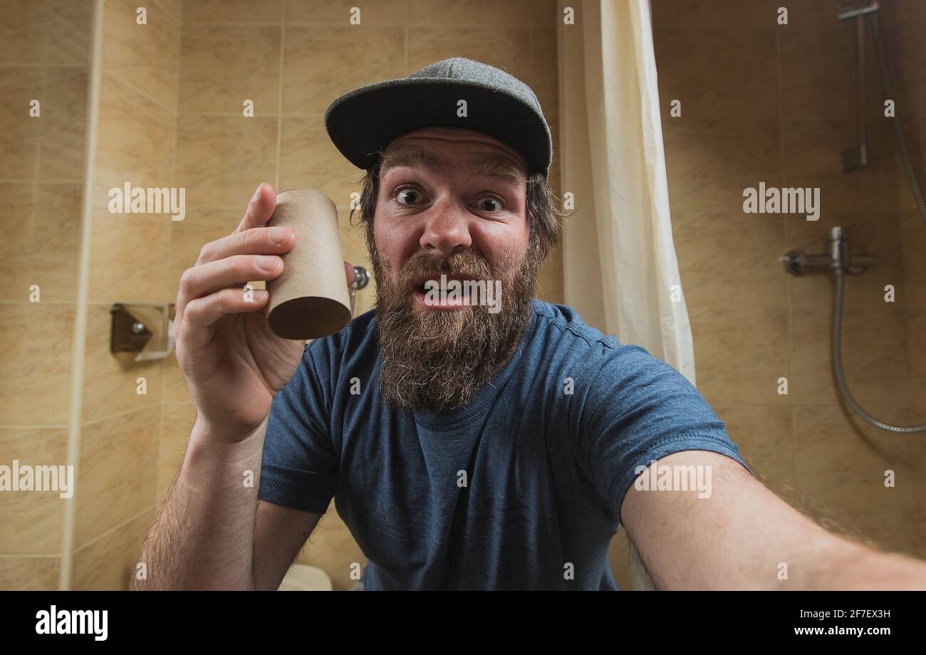 Hipster man with a distressed or disturbed face as he holds an empty ...