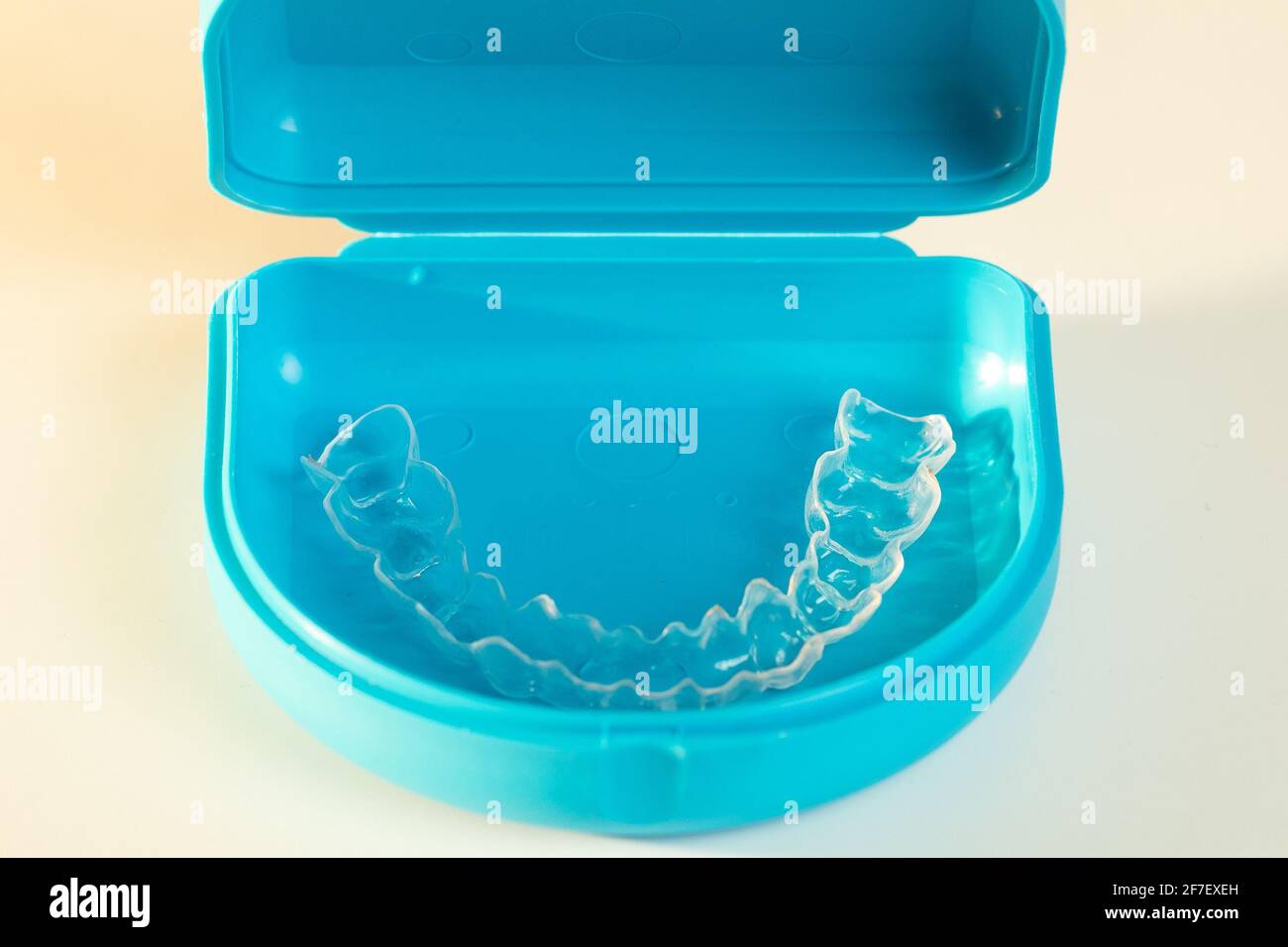 Orthodontic retainer made from transparent plastic in a blue carrying ...