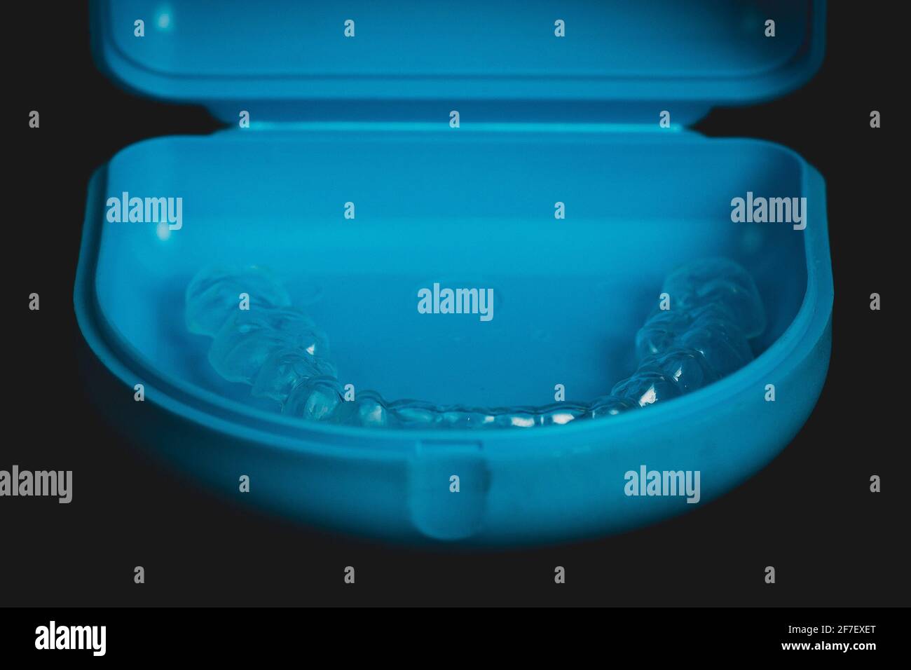 Orthodontic retainer made from transparent plastic in a blue carrying ...