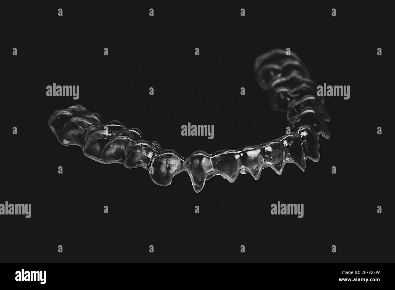 Orthodontic retainer made from transparent plastic isolated on wblack ...