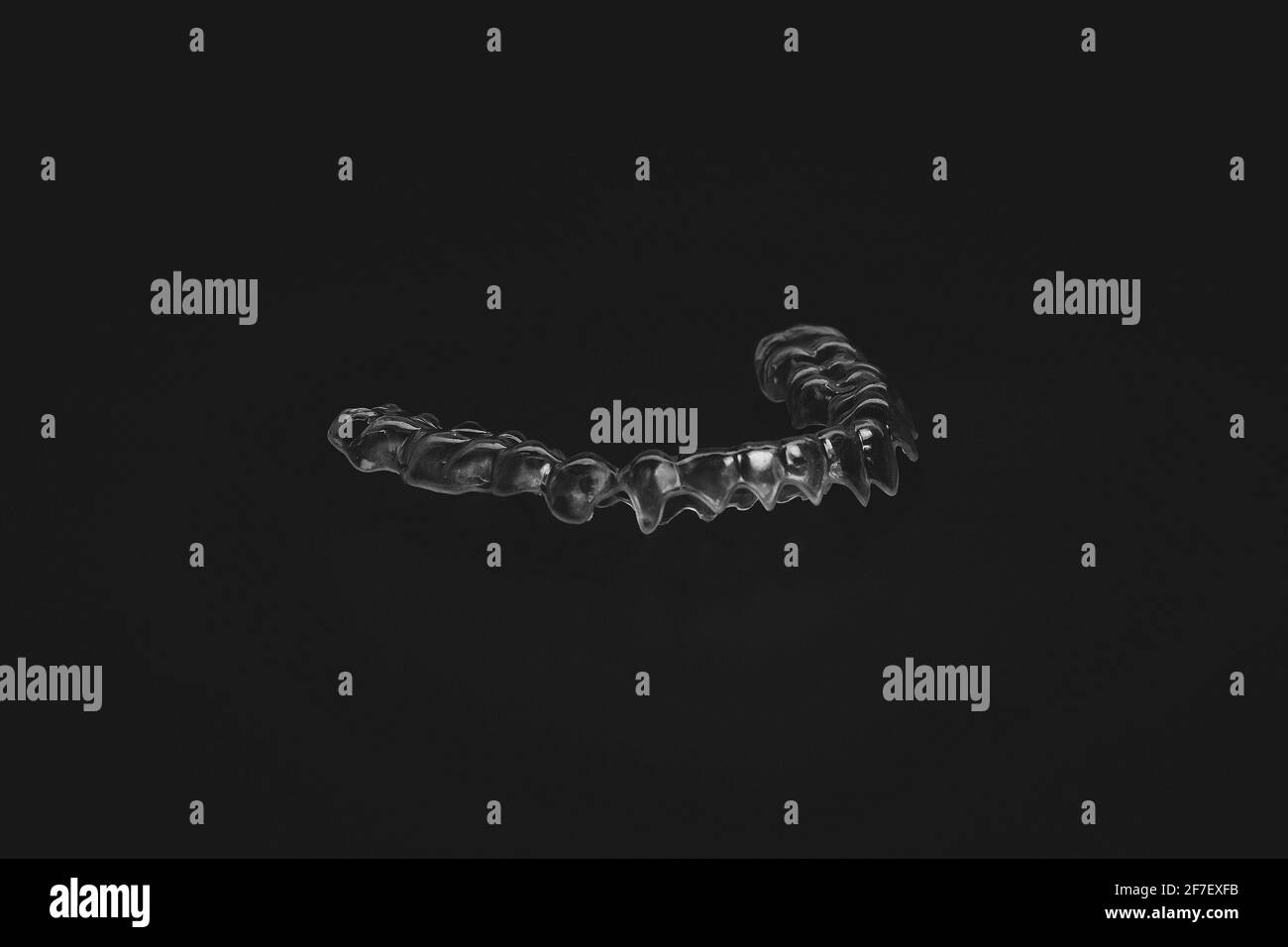 Orthodontic retainer made from transparent plastic isolated on wblack ...