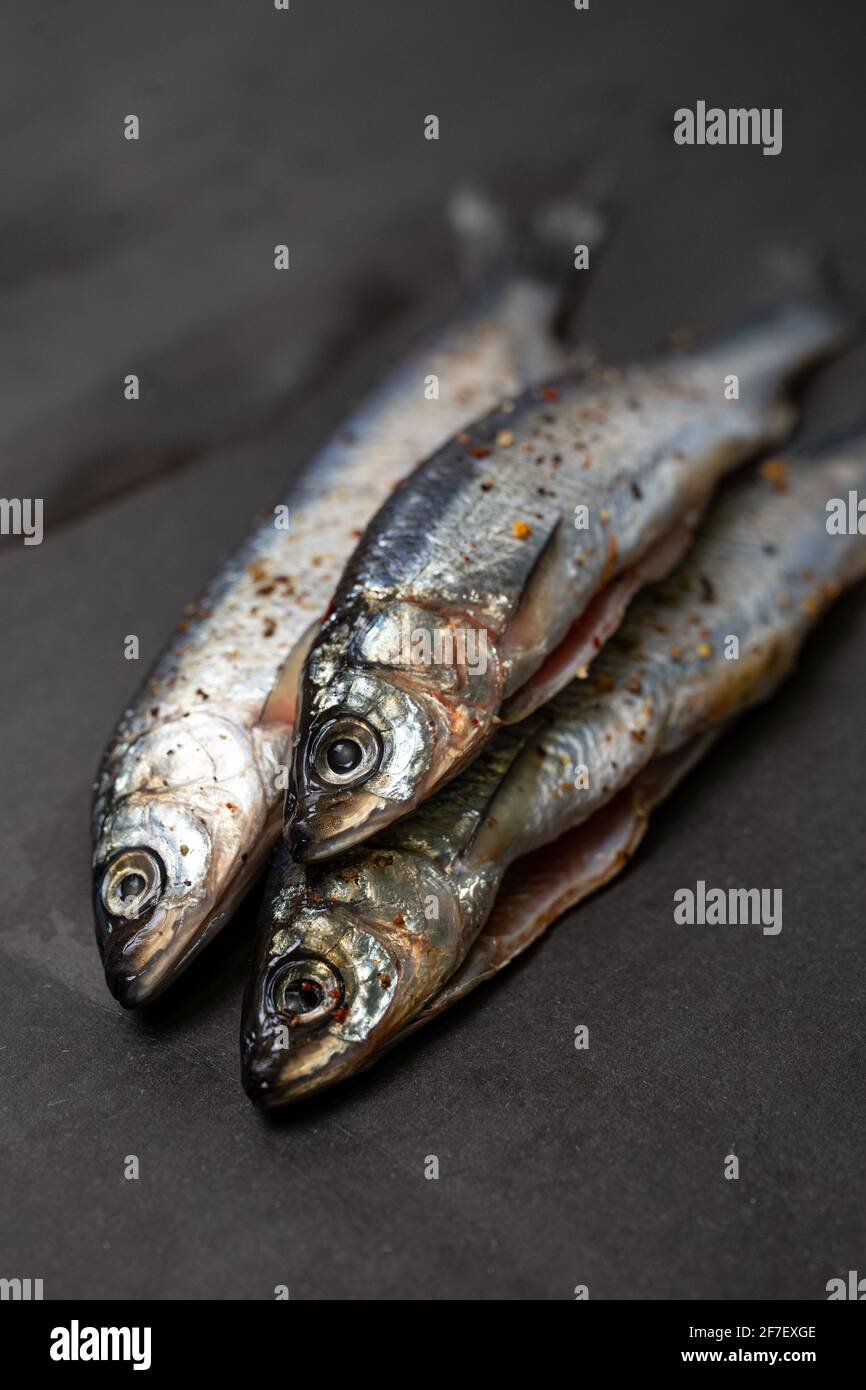 Small river fish marinated on gray background top view Stock Photo - Alamy