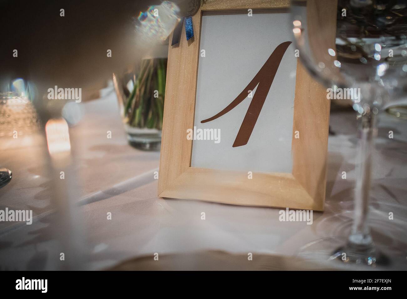 Number one or 1 written in the wooden picture frame on the table ...