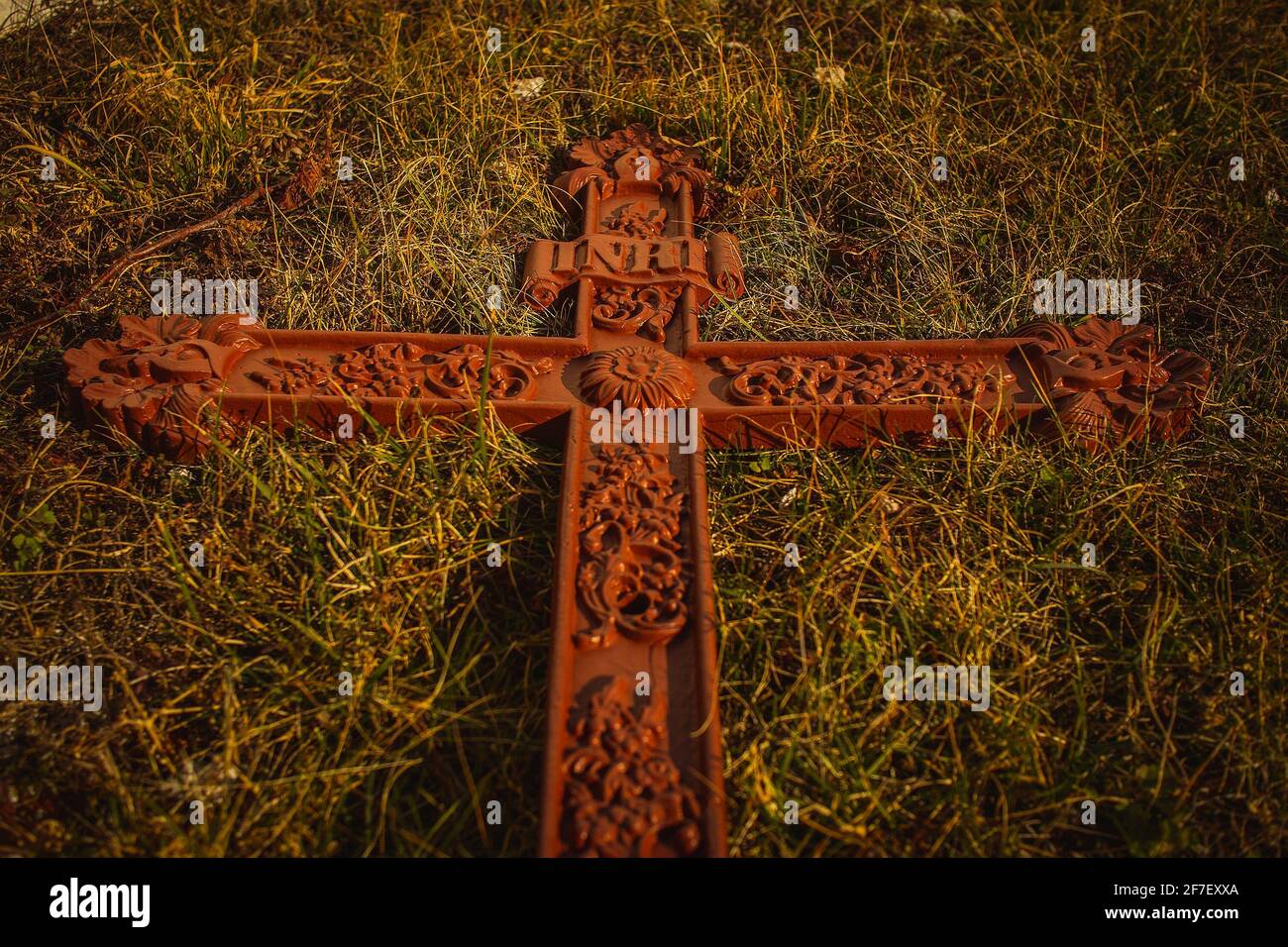 Forgotten and fallen metal crucifix without jesus, renewed in brown ...