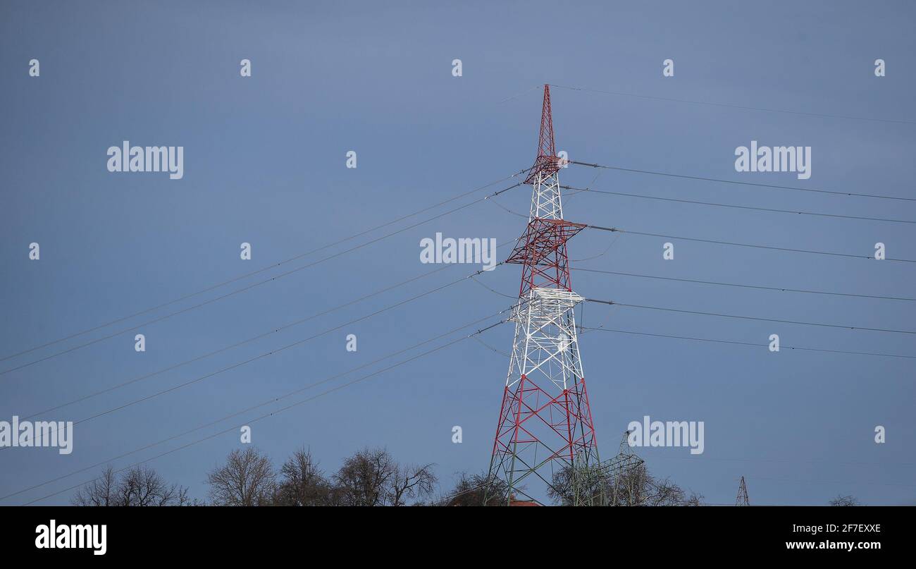 Red and white colored electric power line tower on top of a hill Stock ...