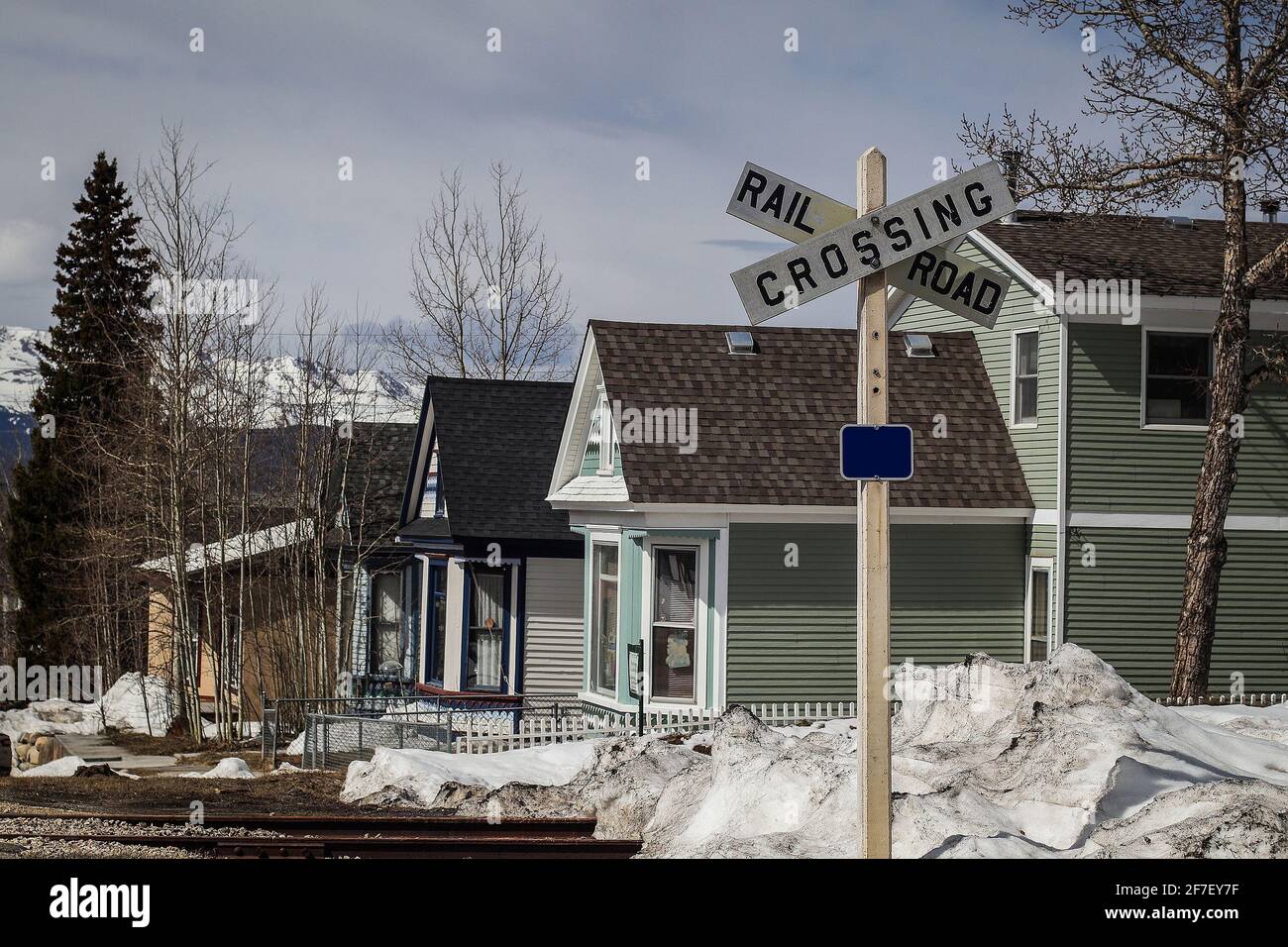 American railroad crossing sign against some houses in Leadville ...