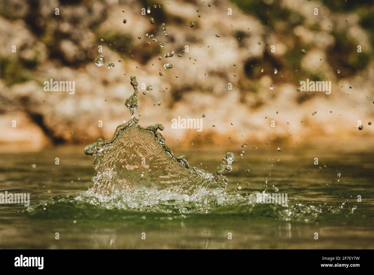 Water splash, some droplets and a wave on natural background. River ...
