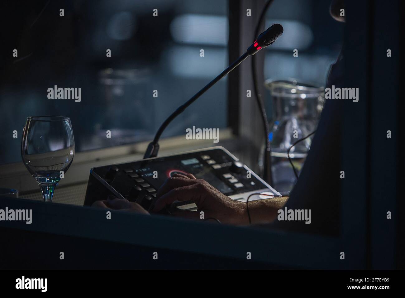 Translator or translation booth at a conference. Hand of a person for ...