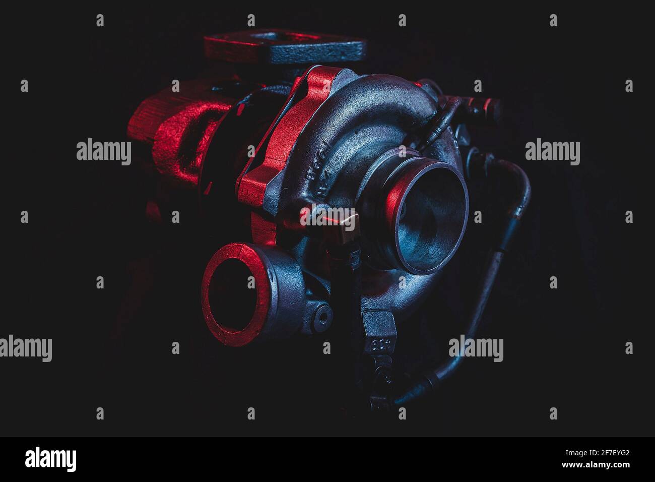 An old reconditioned car turbine, turbocharger, isolated on black with ...