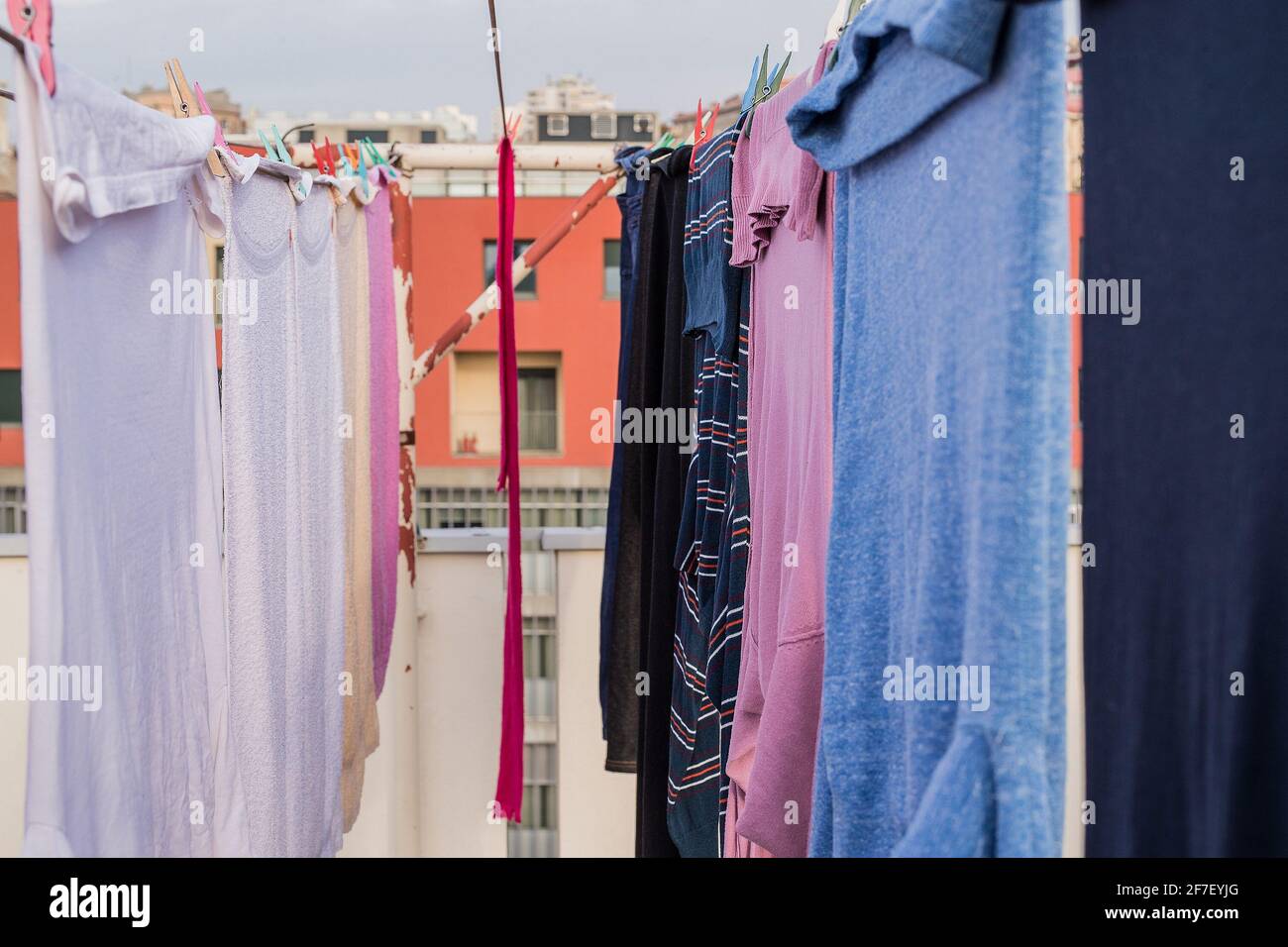 Different clothes being dried on rooftop. Two rows of drying clothes on ...