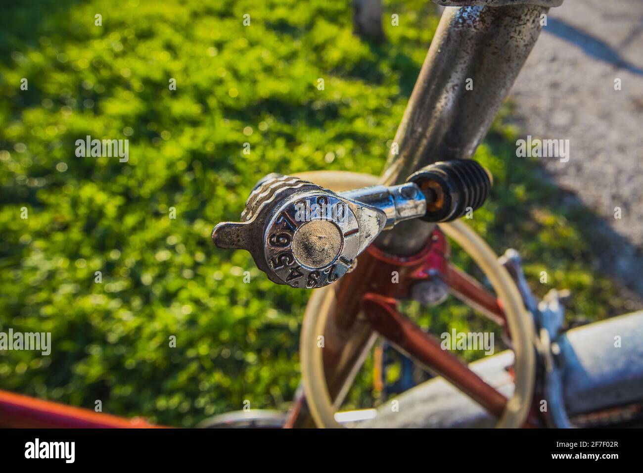 Detail of cheap worn number combination lock on an old bicycle, with ...