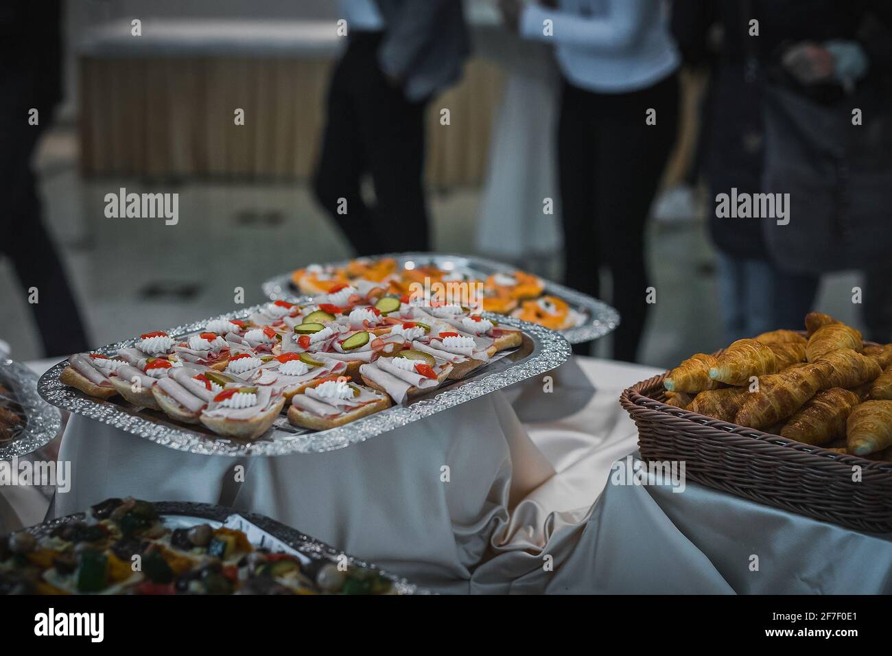 A collection of different snacks and sandwiches on a display on a ...