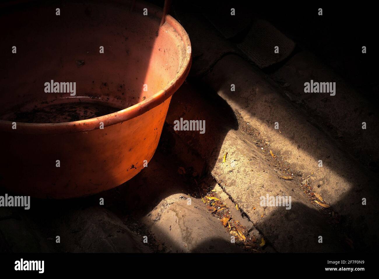 Old worn red bucket standing in a foggy environment on the attic. Red ...