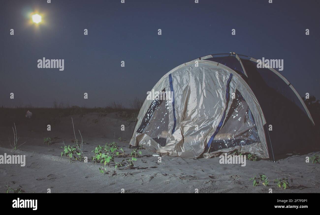 Single igloo tent on a beach during night time. Moon is visible Stock ...