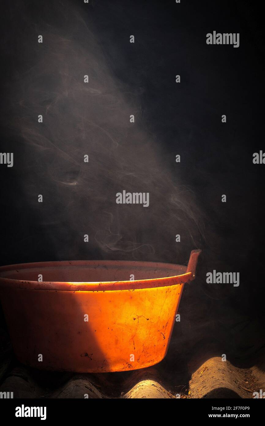 Old worn red bucket standing in a foggy environment on the attic. Red ...