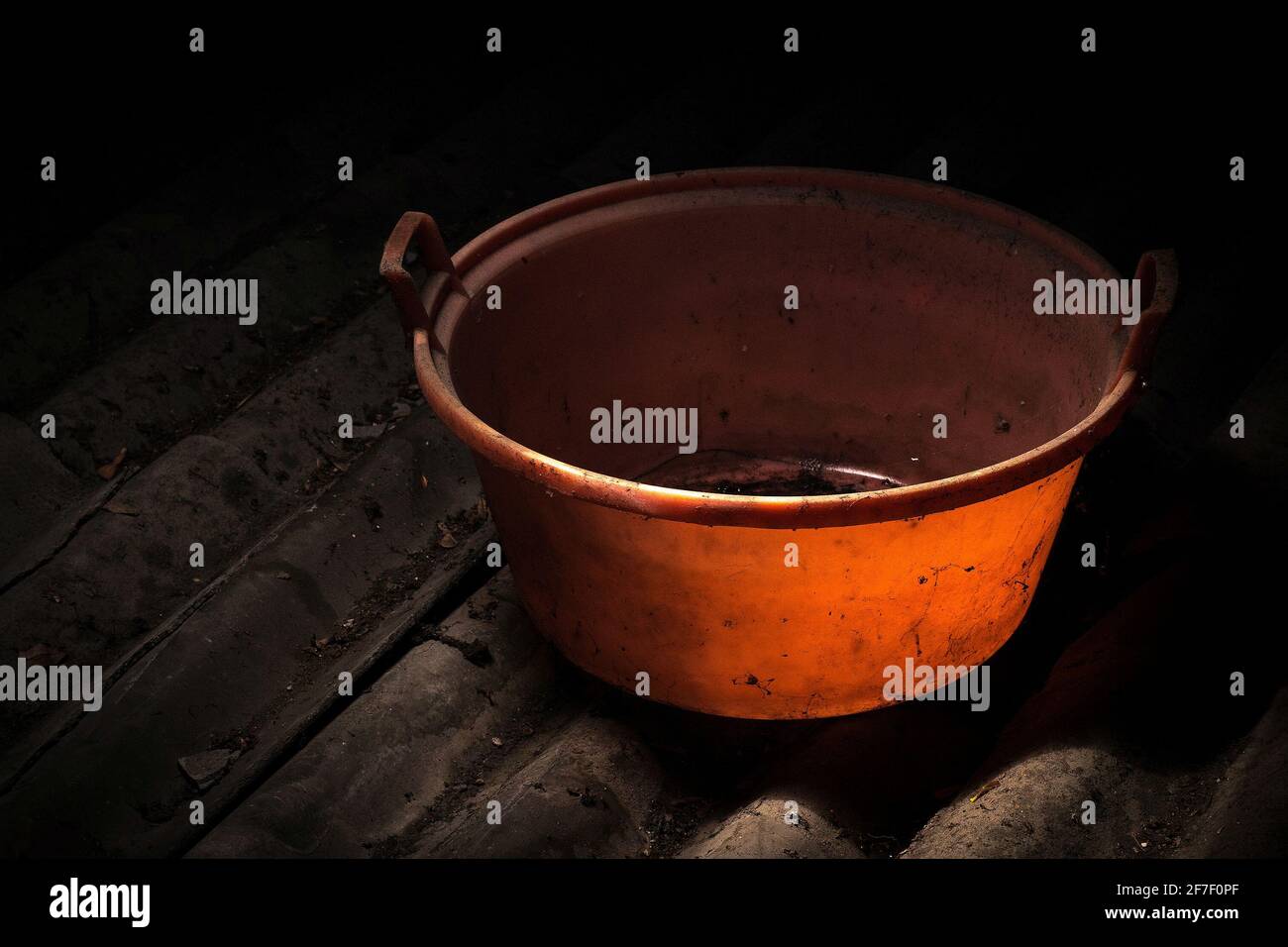 Old worn red bucket standing in a foggy environment on the attic. Red ...