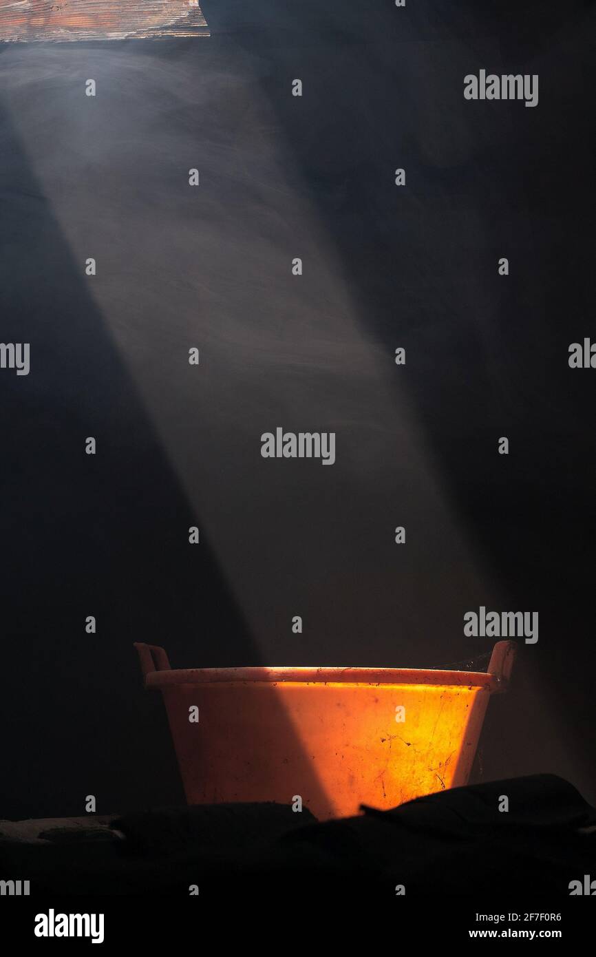 Old worn red bucket standing in a foggy environment on the attic. Red ...