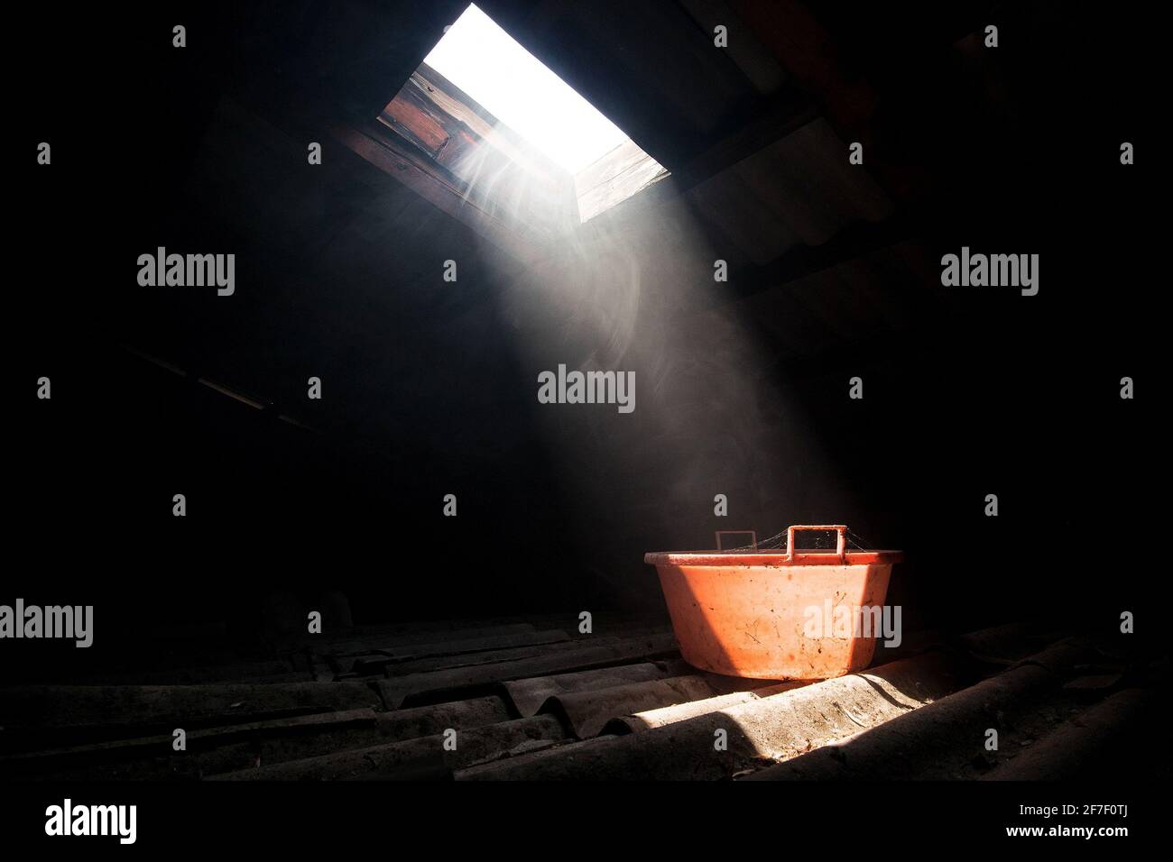 Old worn red bucket standing in a foggy environment on the attic. Red ...