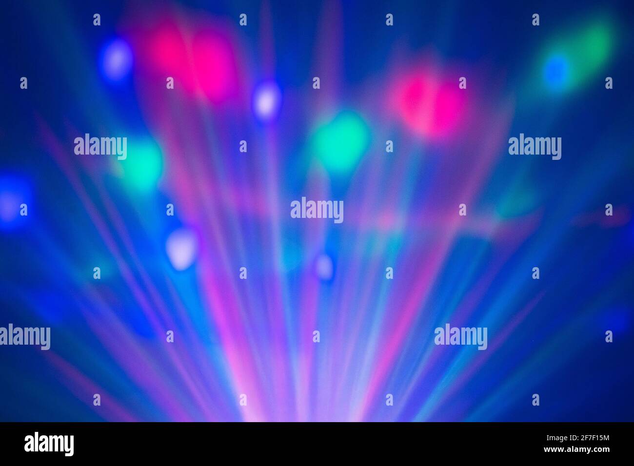 blurred laser light in a disco or night club with visible light rays ...