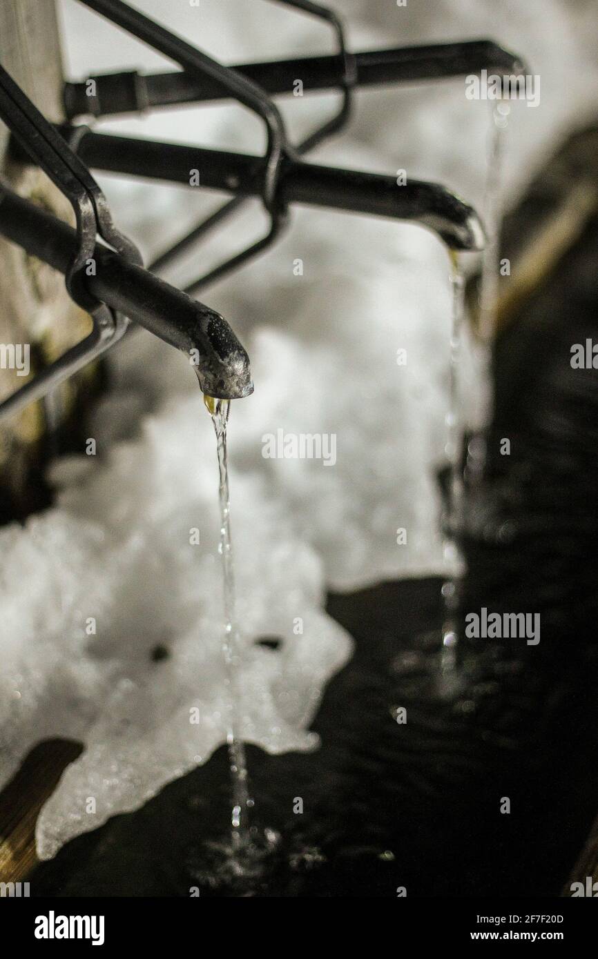Closeup detail of water slowly pouring out of a water fountain in the ...