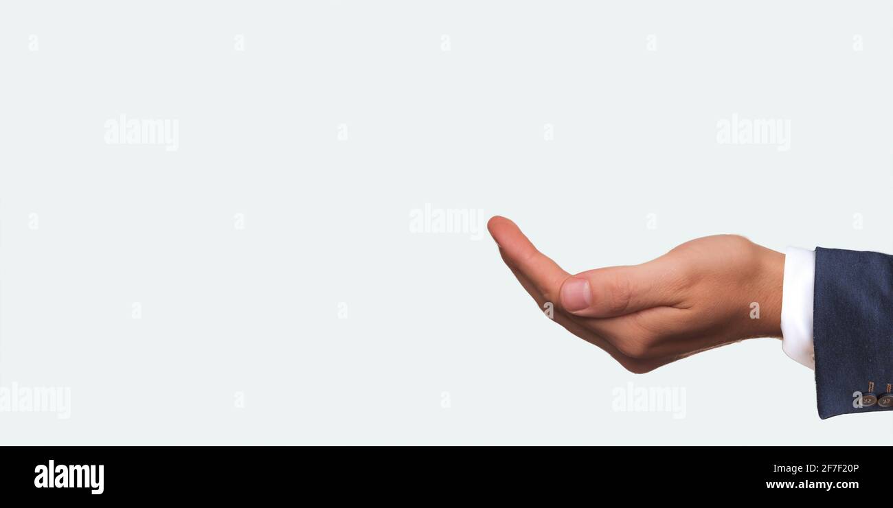 Businessman holding hand out in presentation on white background Stock ...